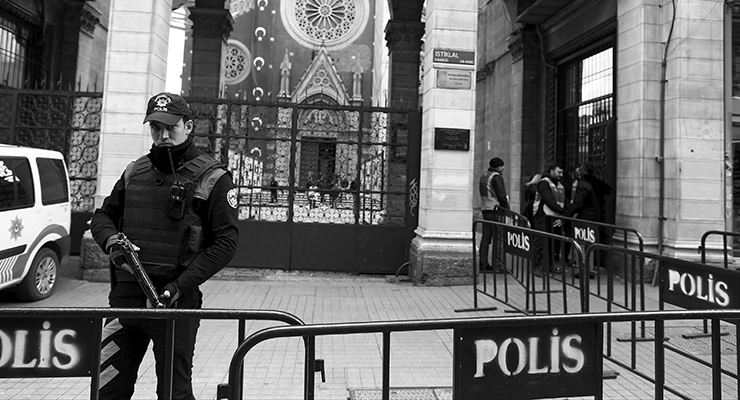 A Turkish police officer stands guard in front of St Antouan Church at ...